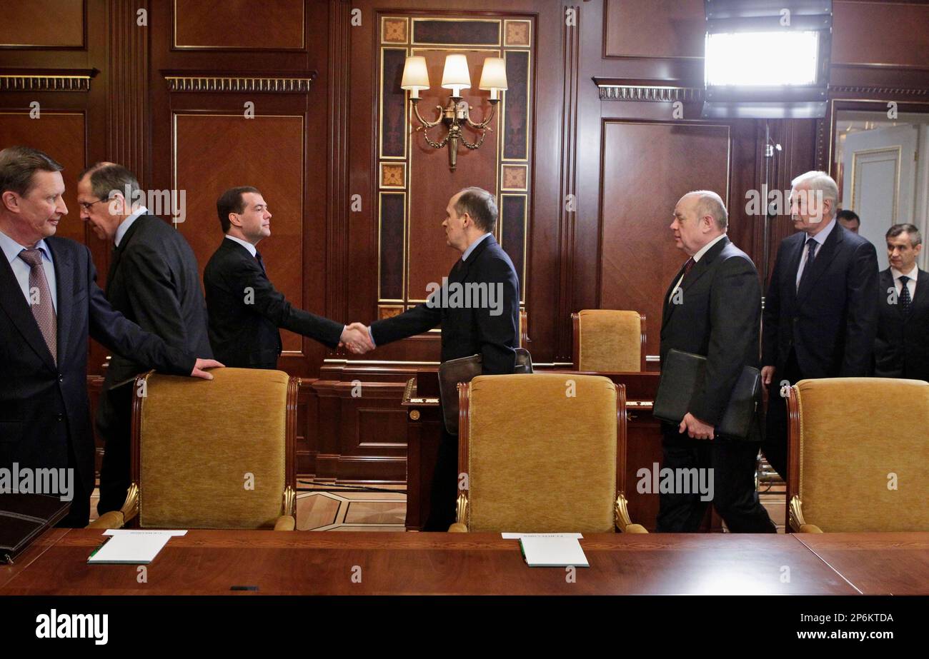 Russian President Dmitry Medvedev, third left, shakes hands with ...