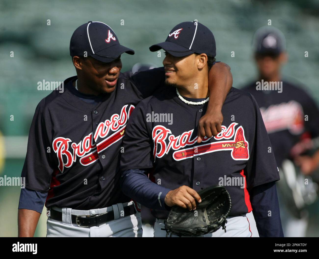 Atlanta Braves pitcher Cristhian Martinez, left, hangs his arm around ...