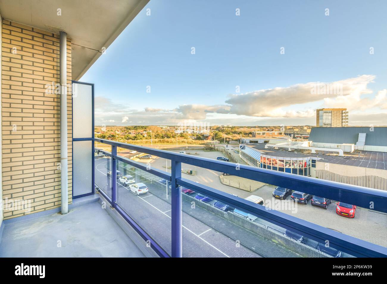 a balcony with cars parked on the street and buildings in the ...
