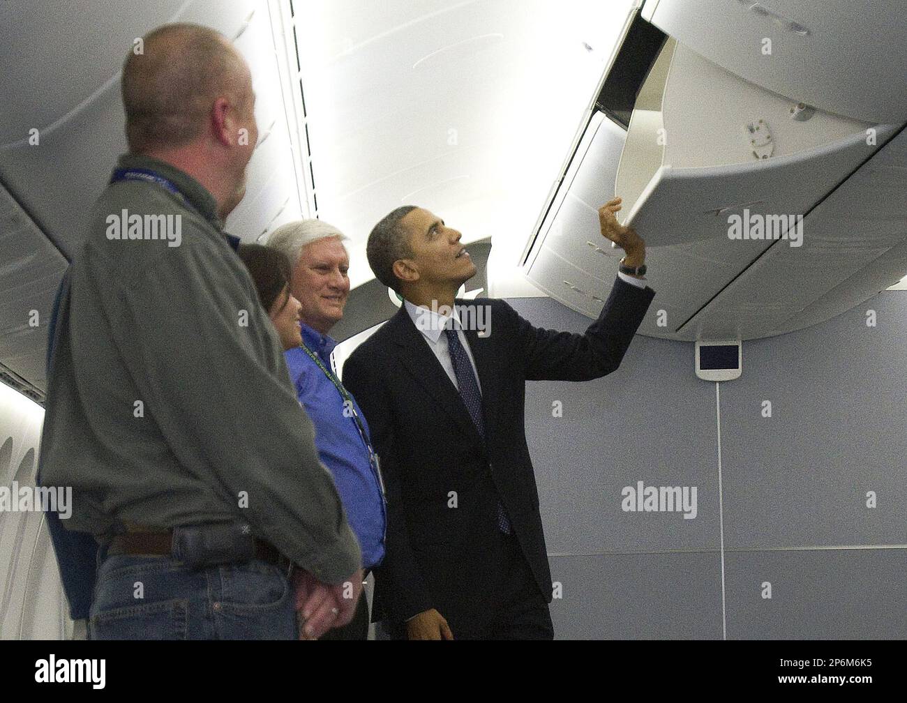 President Barack Obama checks out the overhead storage compartments ...