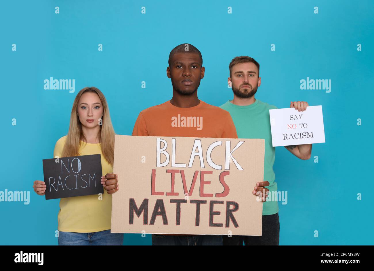 Group of people holding signs on light blue background. Racism concept ...