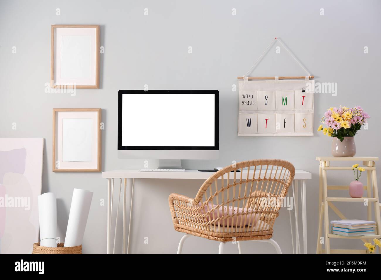 Comfortable workplace with modern computer and flowers in room ...