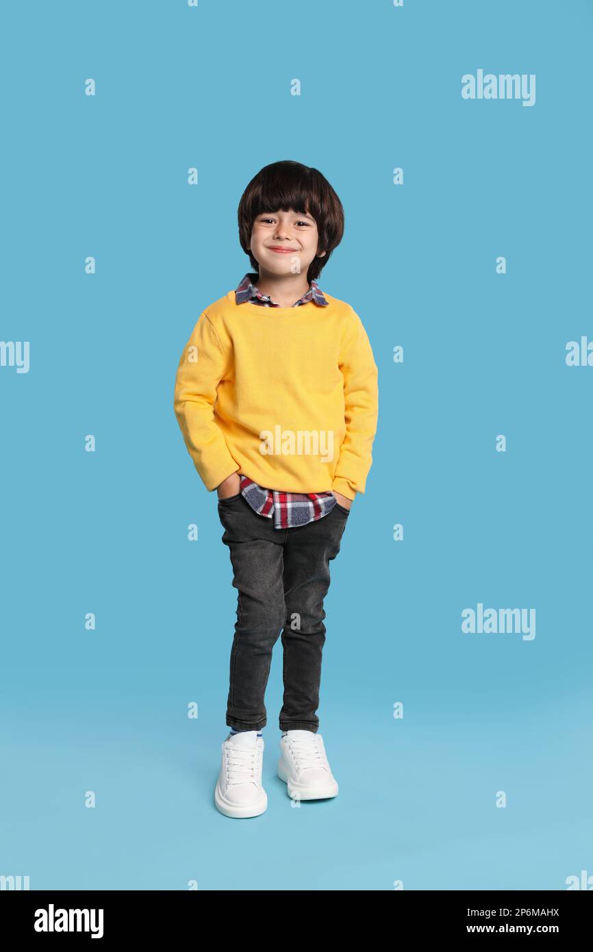 Full length portrait of cute little boy on light blue background Stock ...