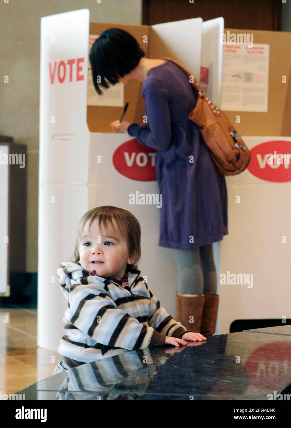 Clark Pogemiller, 15-months, waits as his mother Ellen Pogemiller fills ...