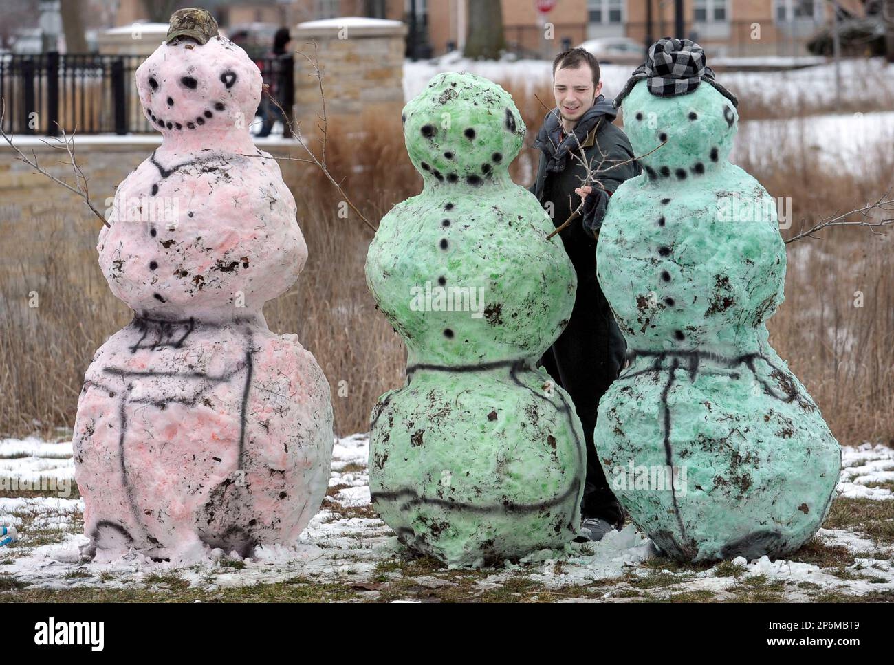 Roger Fritsch, Champaign, puts the finishing touches on three snow ...