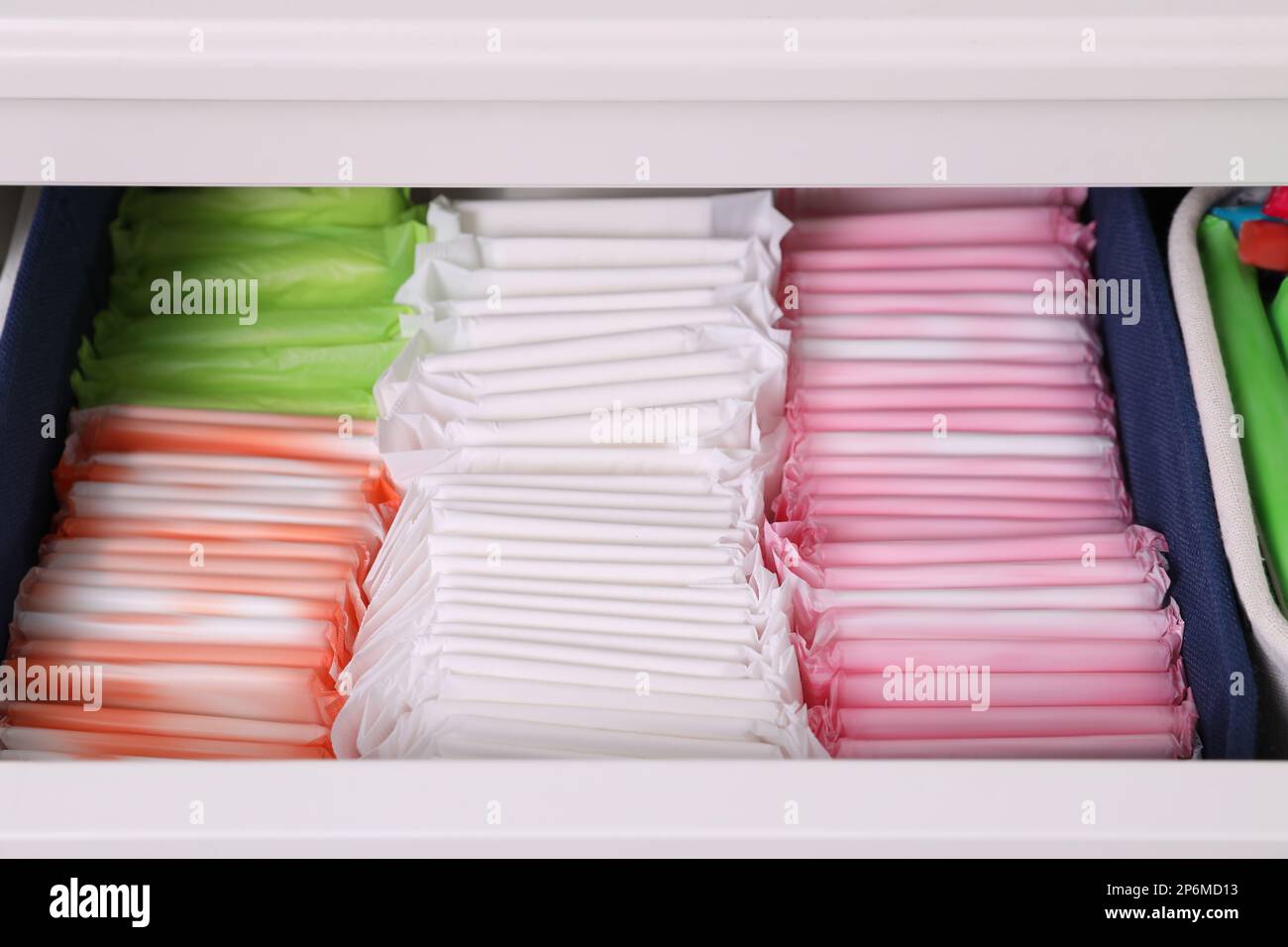 Open cabinet drawer with different menstrual pads, closeup Stock Photo ...