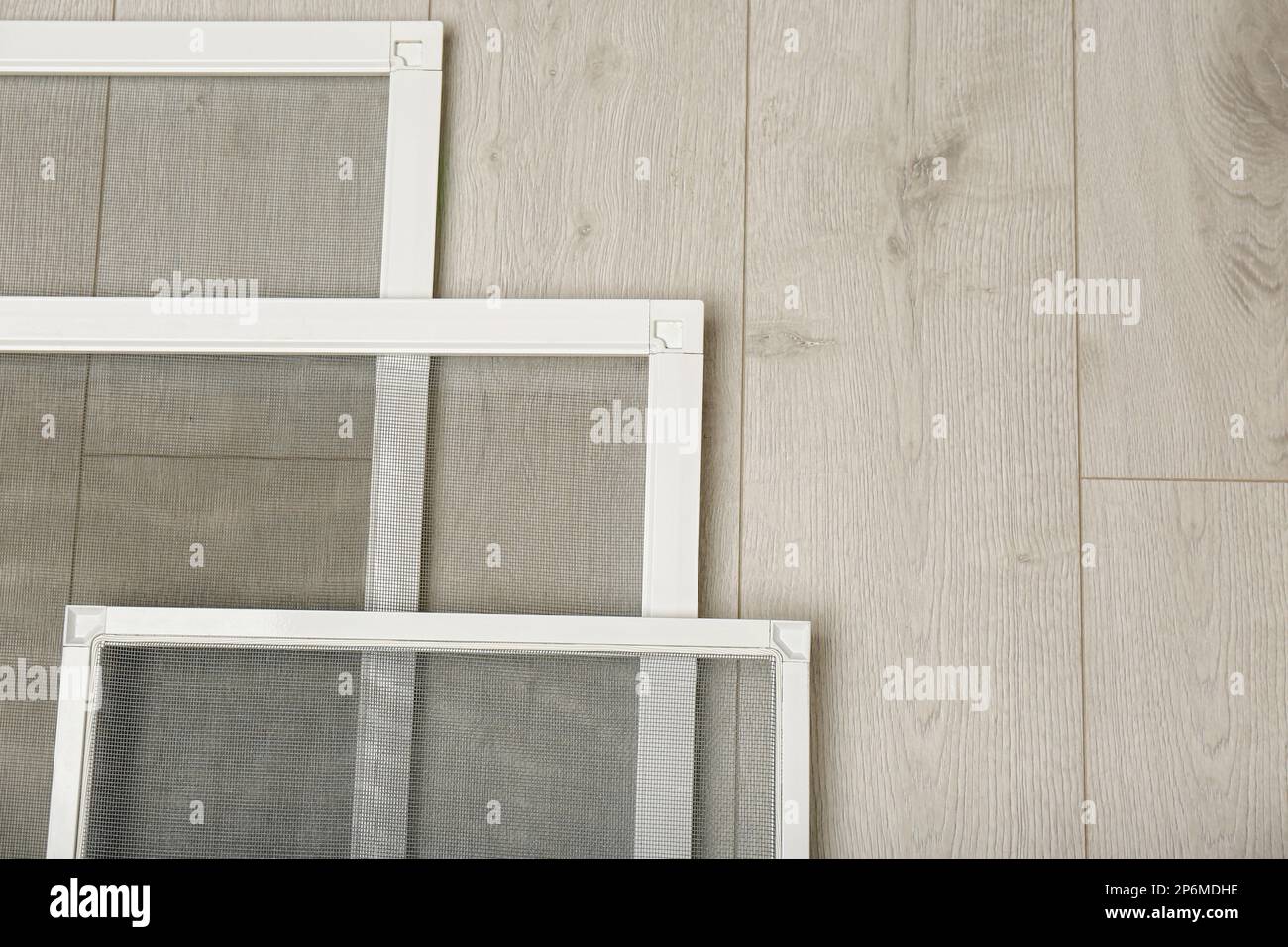 Set of window screens on wooden floor, flat lay. Space for text Stock ...