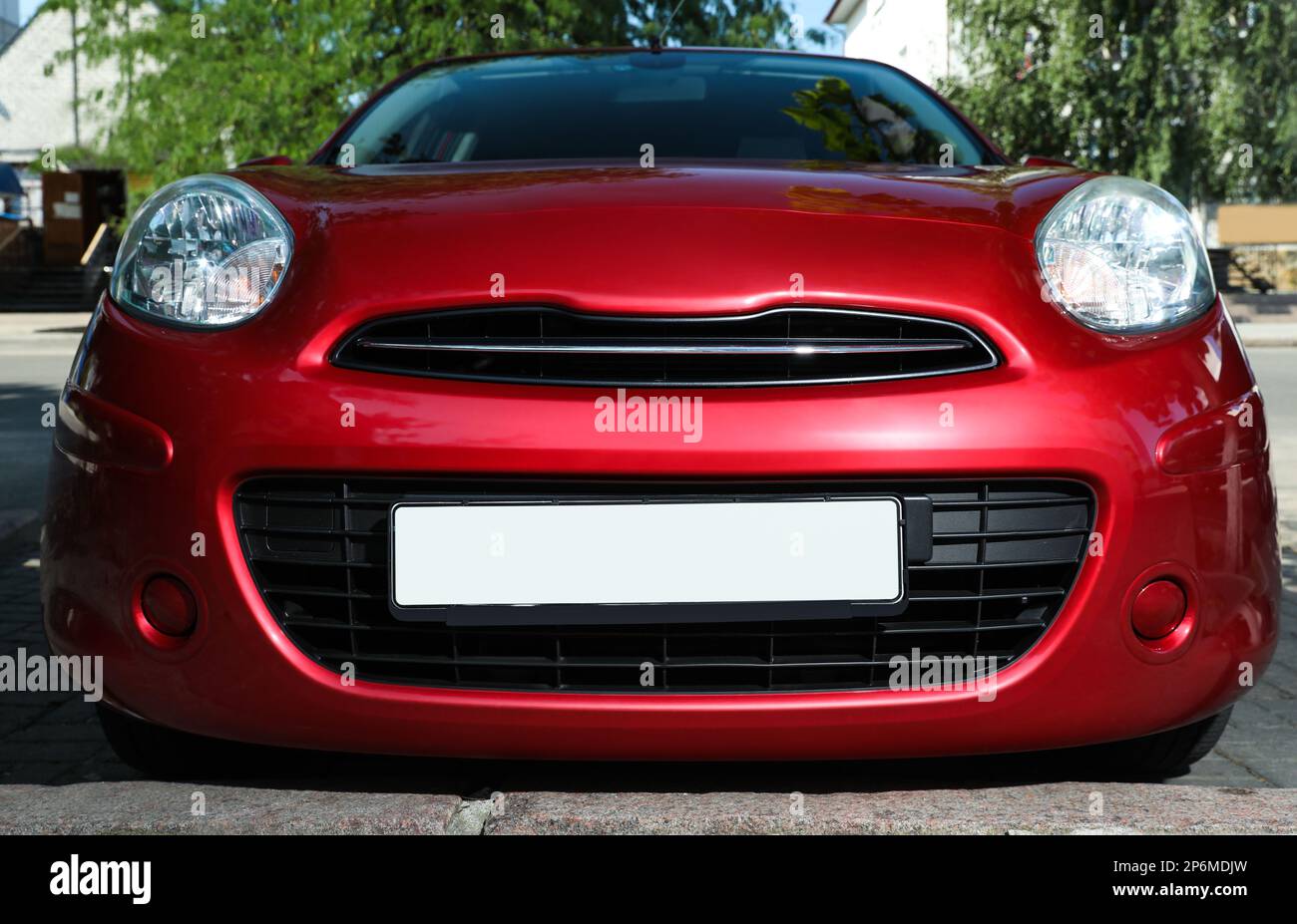Red car with vehicle registration plate outdoors Stock Photo - Alamy