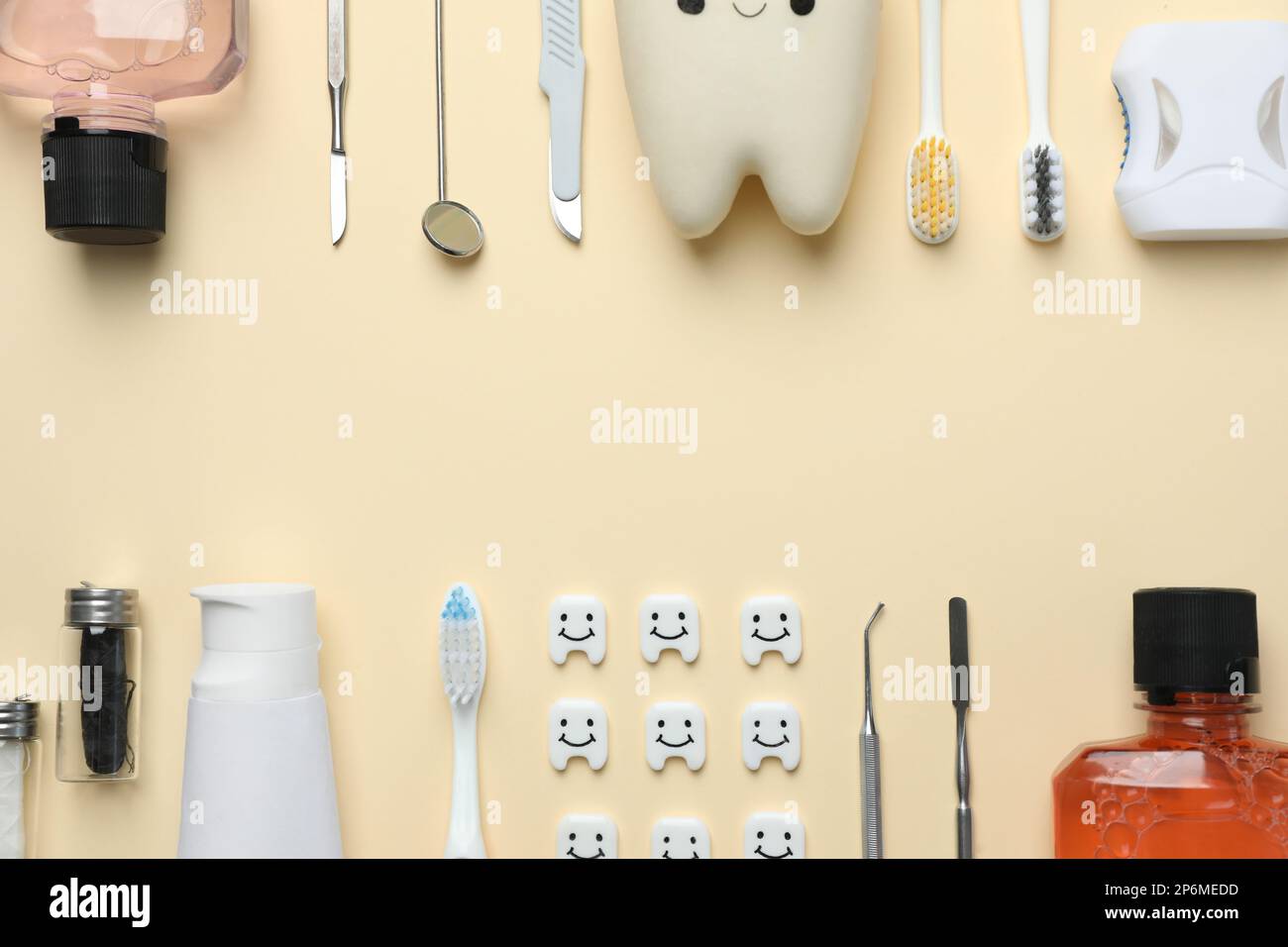 Plastic teeth with cute faces, oral care products and dental tools on ...