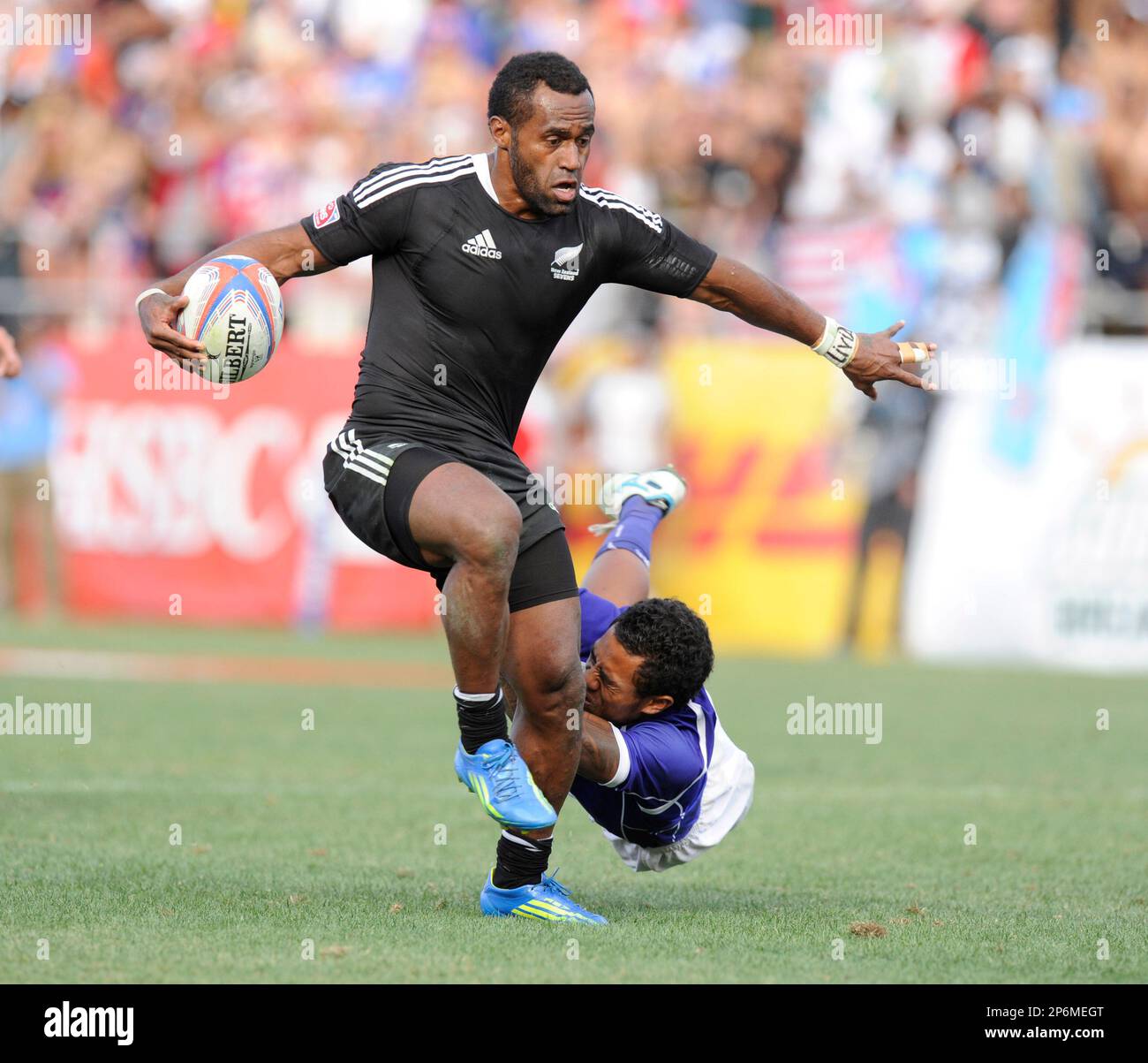 2012 FEB 12: New Zealand's Tomasi Cama eludes Samoa's Tom Iosefo (blue ...