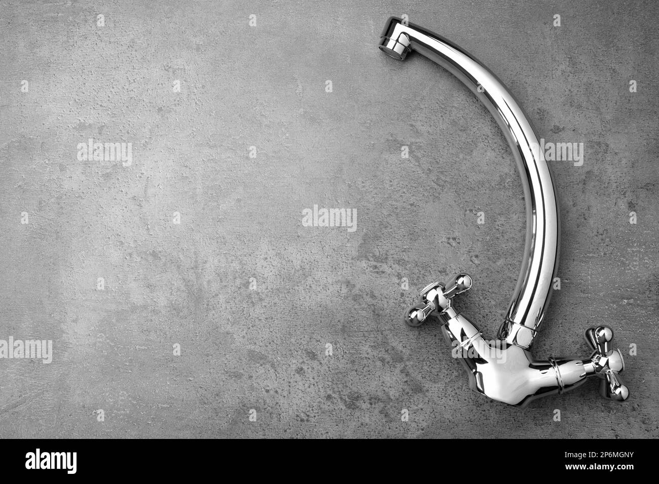 Double handle water tap on grey table, top view. Space for text Stock ...