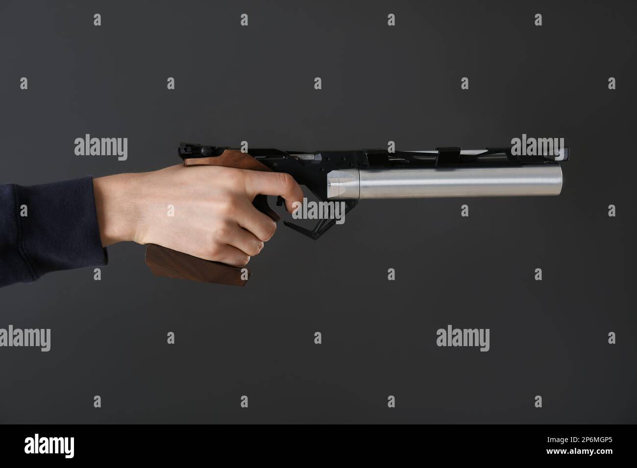 Gun shooting sport. Man aiming standard pistol on dark background ...