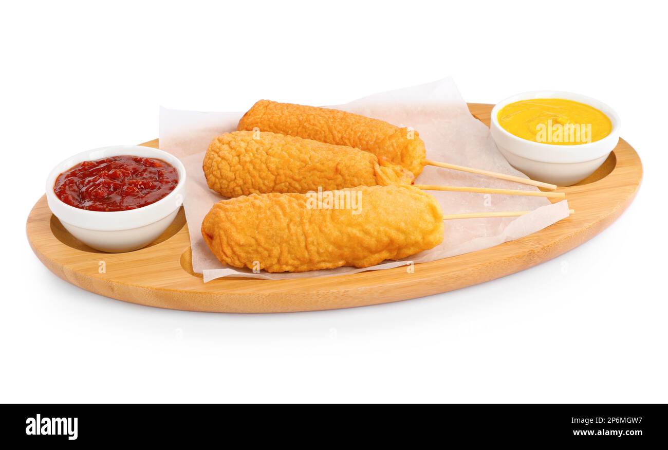 Delicious deep fried corn dogs with board and sauces isolated on white ...
