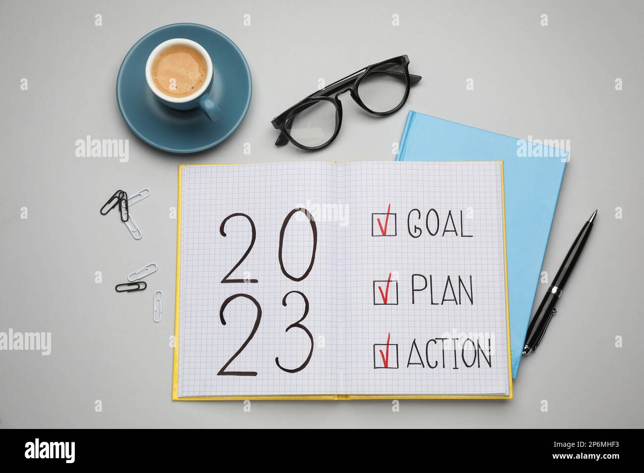 Flat lay composition of notebook with text 2023 Goal, Plan, Action on light grey background. New ...