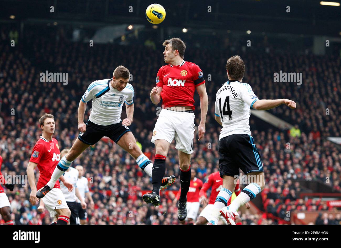 Manchester United's Michael Carrick, centre, jumps for the ball against ...