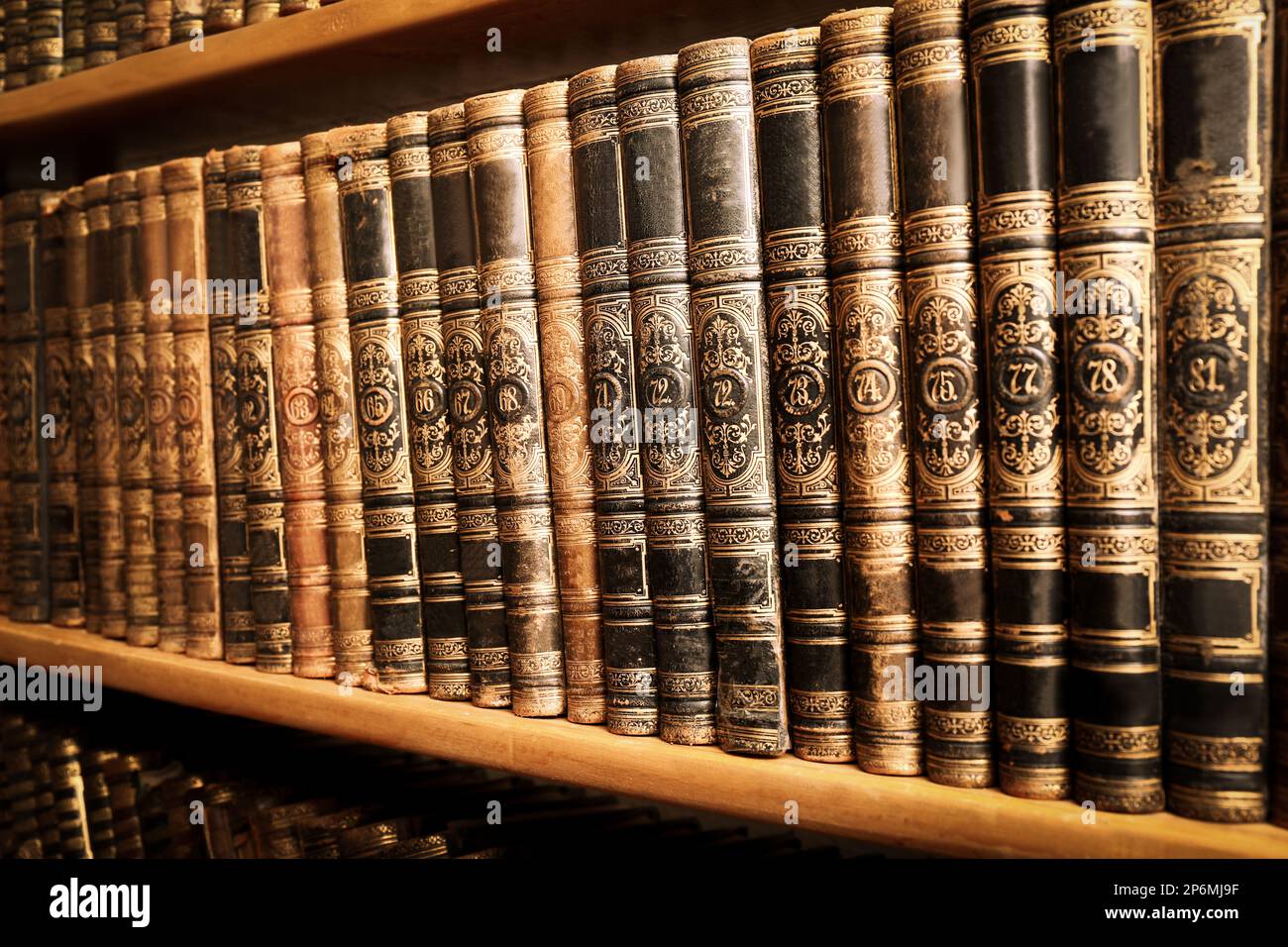 Collection of old books on shelf in library Stock Photo - Alamy