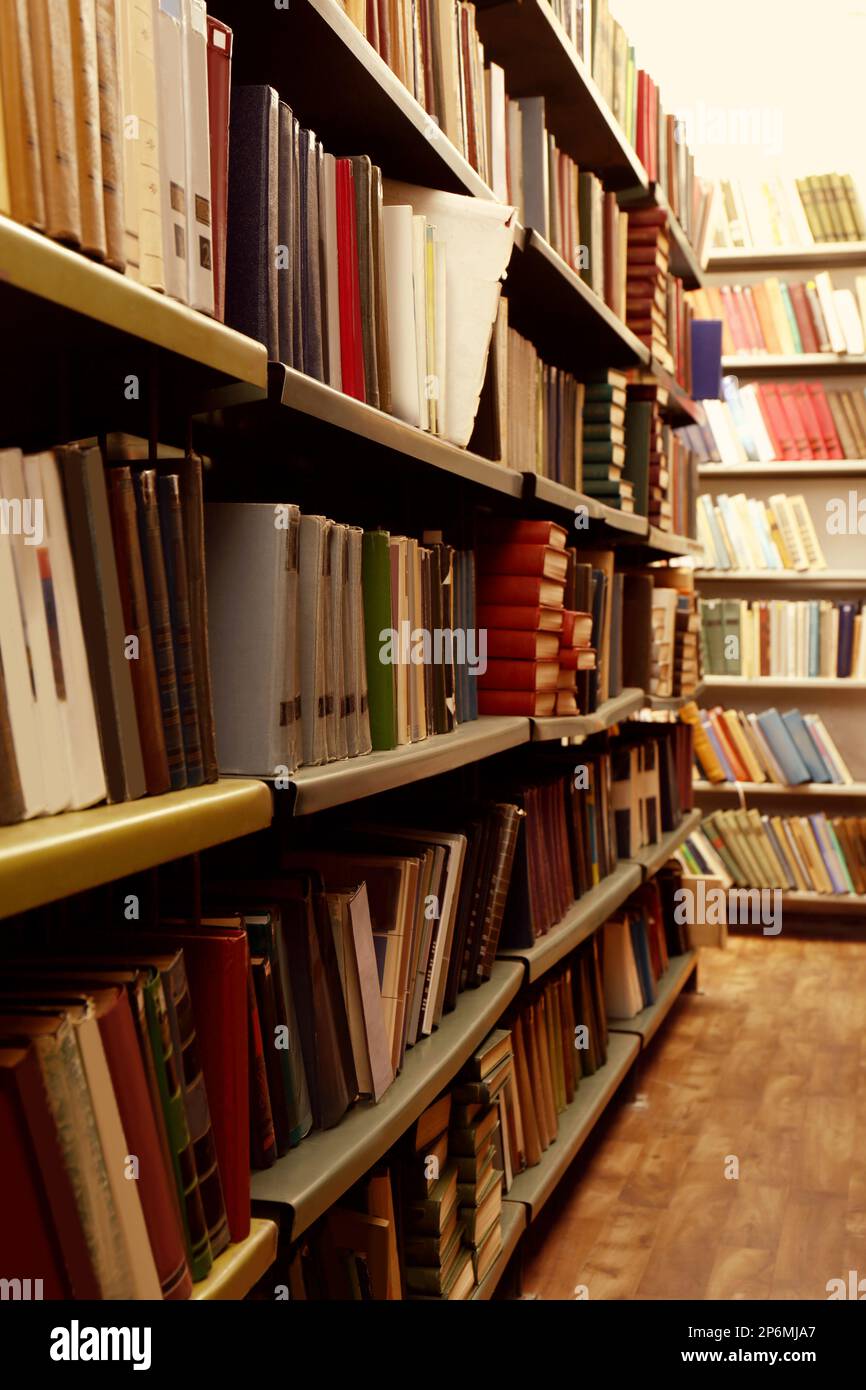 Collection of different books on shelves in library Stock Photo - Alamy