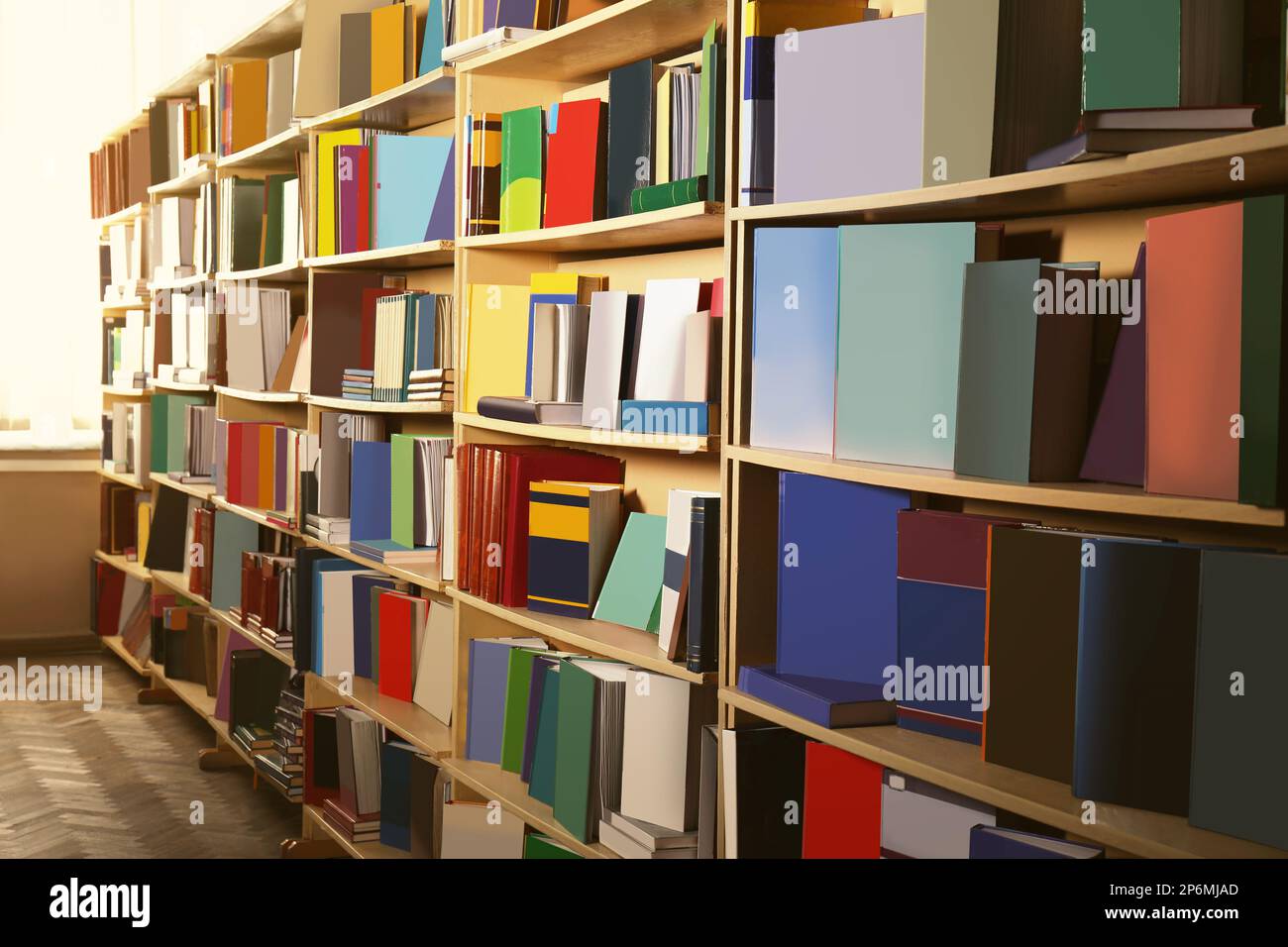 Collection of different books on shelves in library Stock Photo - Alamy