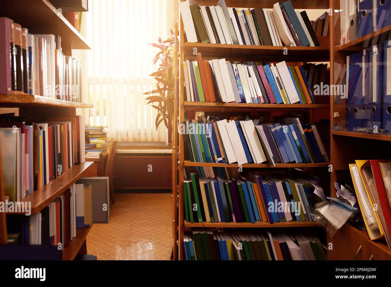 Collection of different books on shelves in library Stock Photo - Alamy