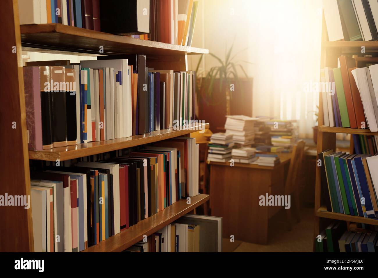 Collection of different books on shelves in library Stock Photo - Alamy