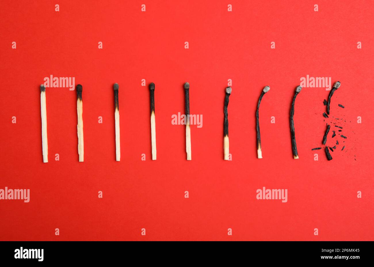 Different stages of burnt matches on red background, flat lay Stock ...