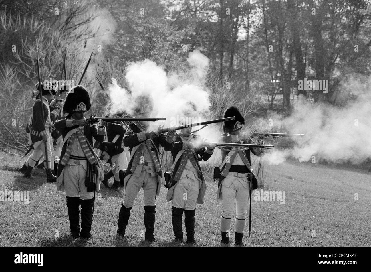 Red Coats fire their muskets on the colonists below them during a ...