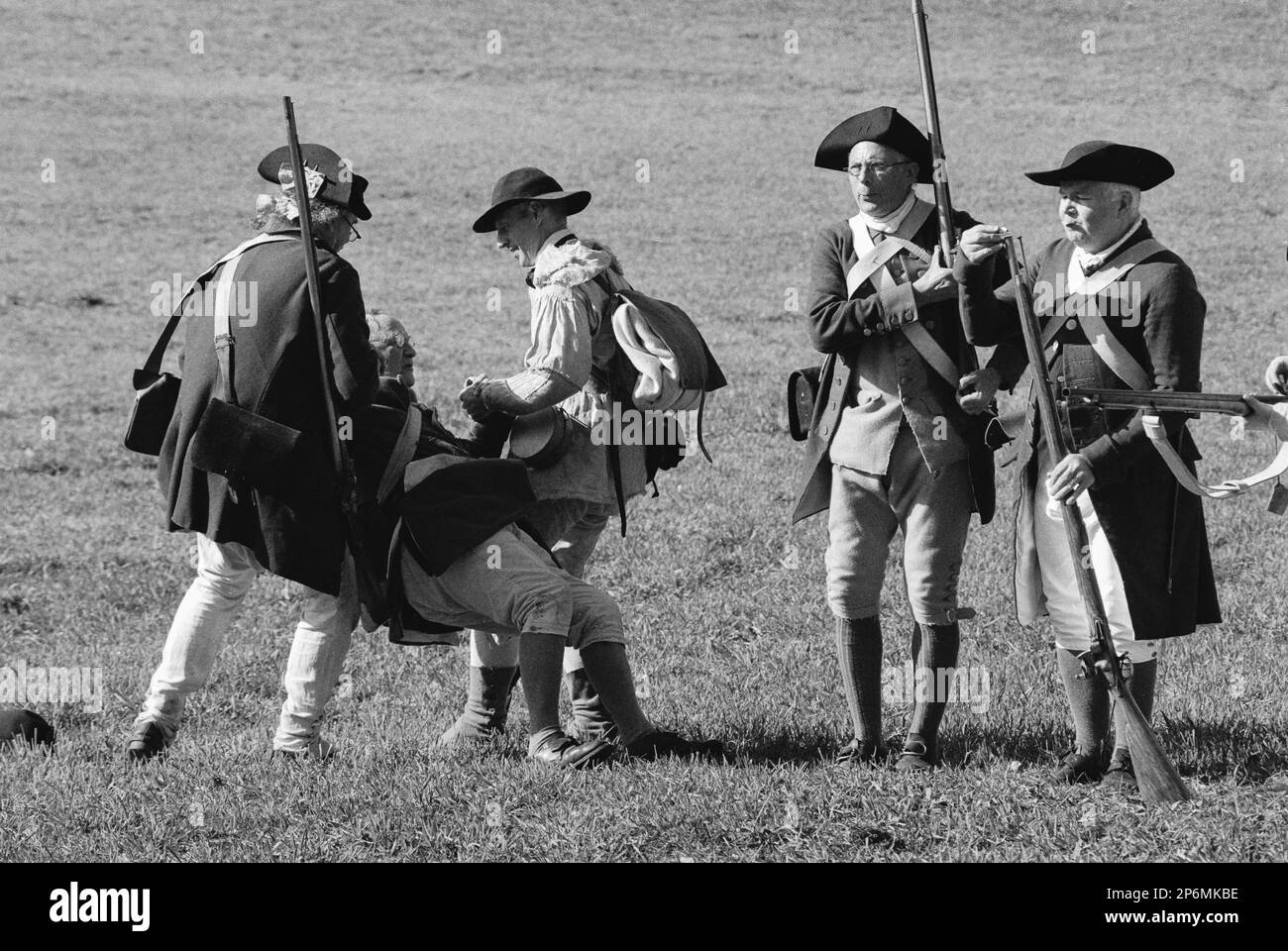 Actors in period costumes appear as injured or dead on the battlefield ...