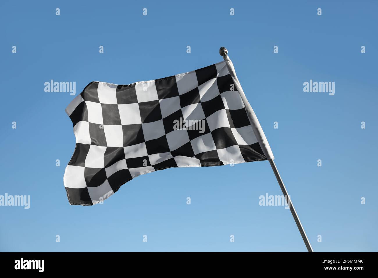 Checkered finish flag on light blue background Stock Photo - Alamy