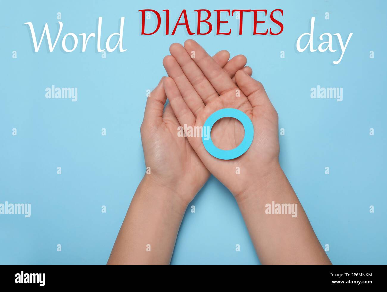 Woman showing blue paper circle as World Diabetes Day symbol on color ...