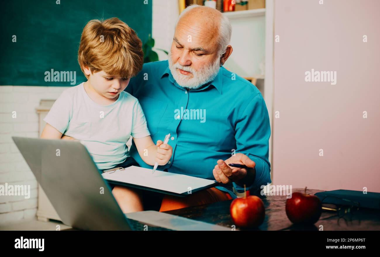 Back to school. Teacher and pupil learning together in school Stock ...