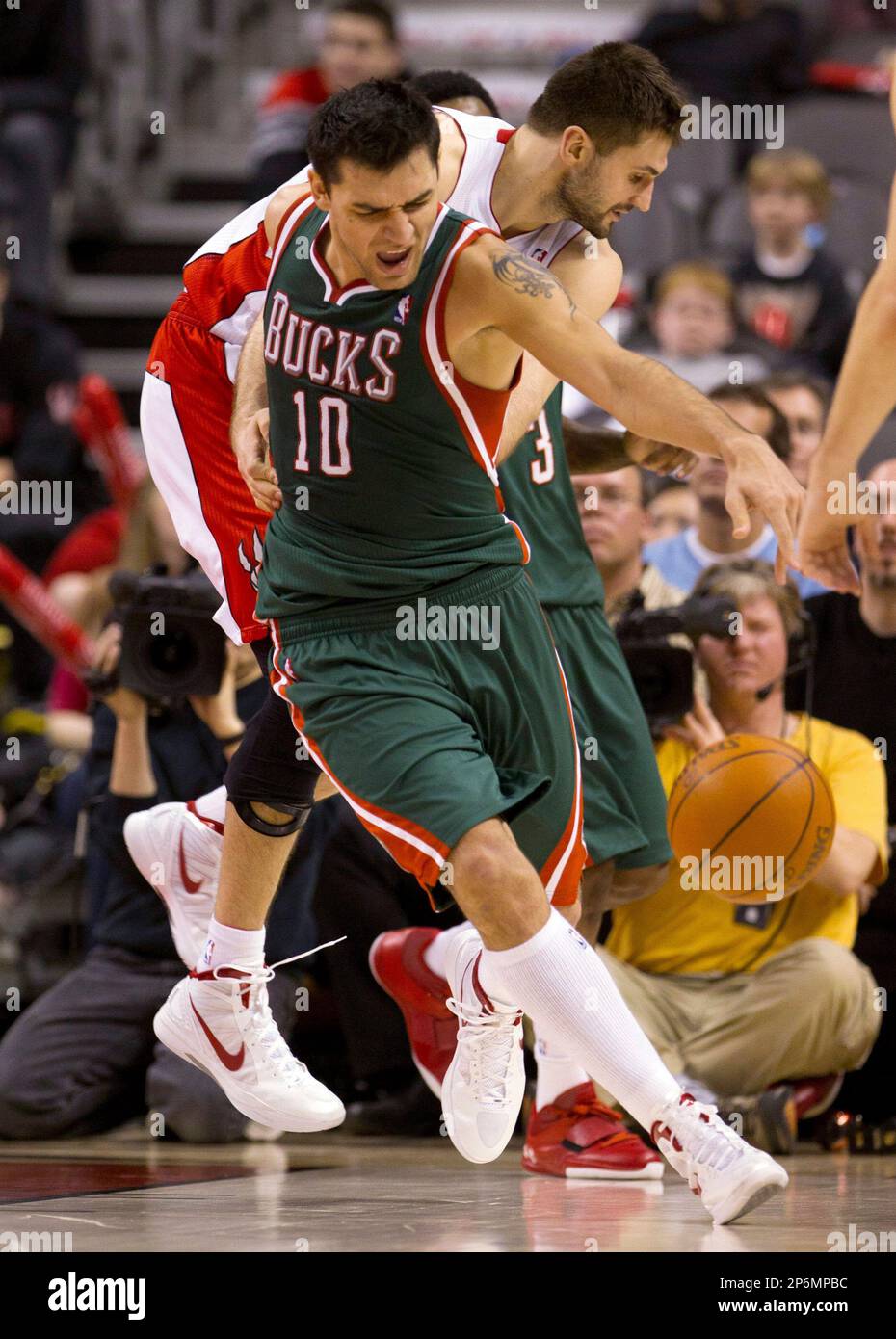 Milwaukee Bucks guard Carlos Delfino (10) is fouled by Toronto Raptors ...
