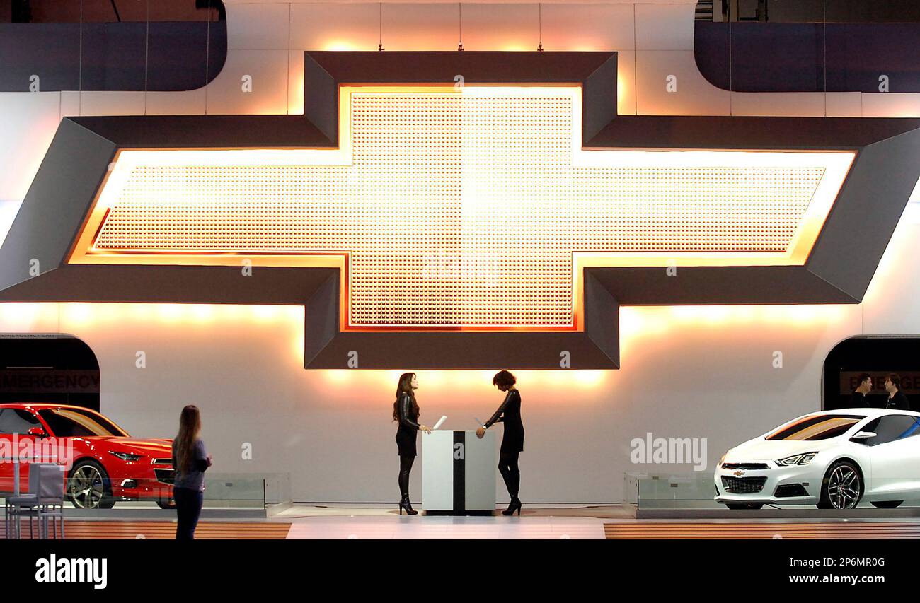 Chevrolet concept cars sit under their logo sign waiting for patrons to ...