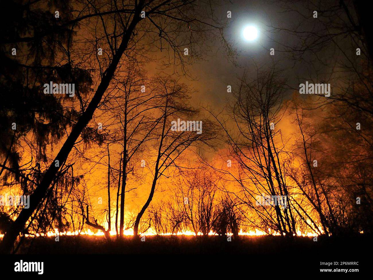 In this Feb. 6, 2012, photo, a full moon is visible through the haze of ...