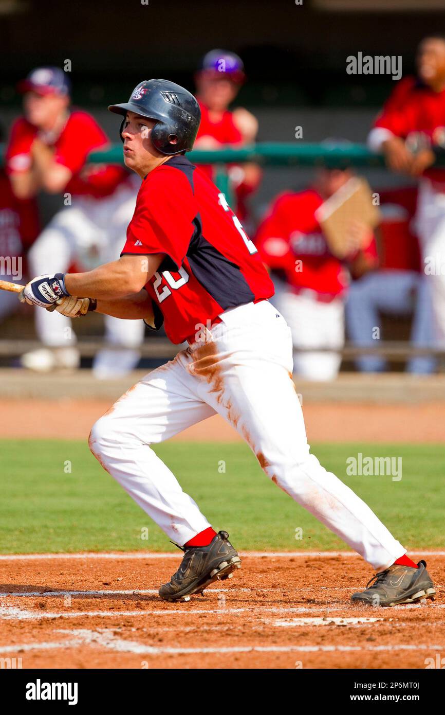 Ty Moore #20 of Babe Ruth follows through on his swing against AABC at ...