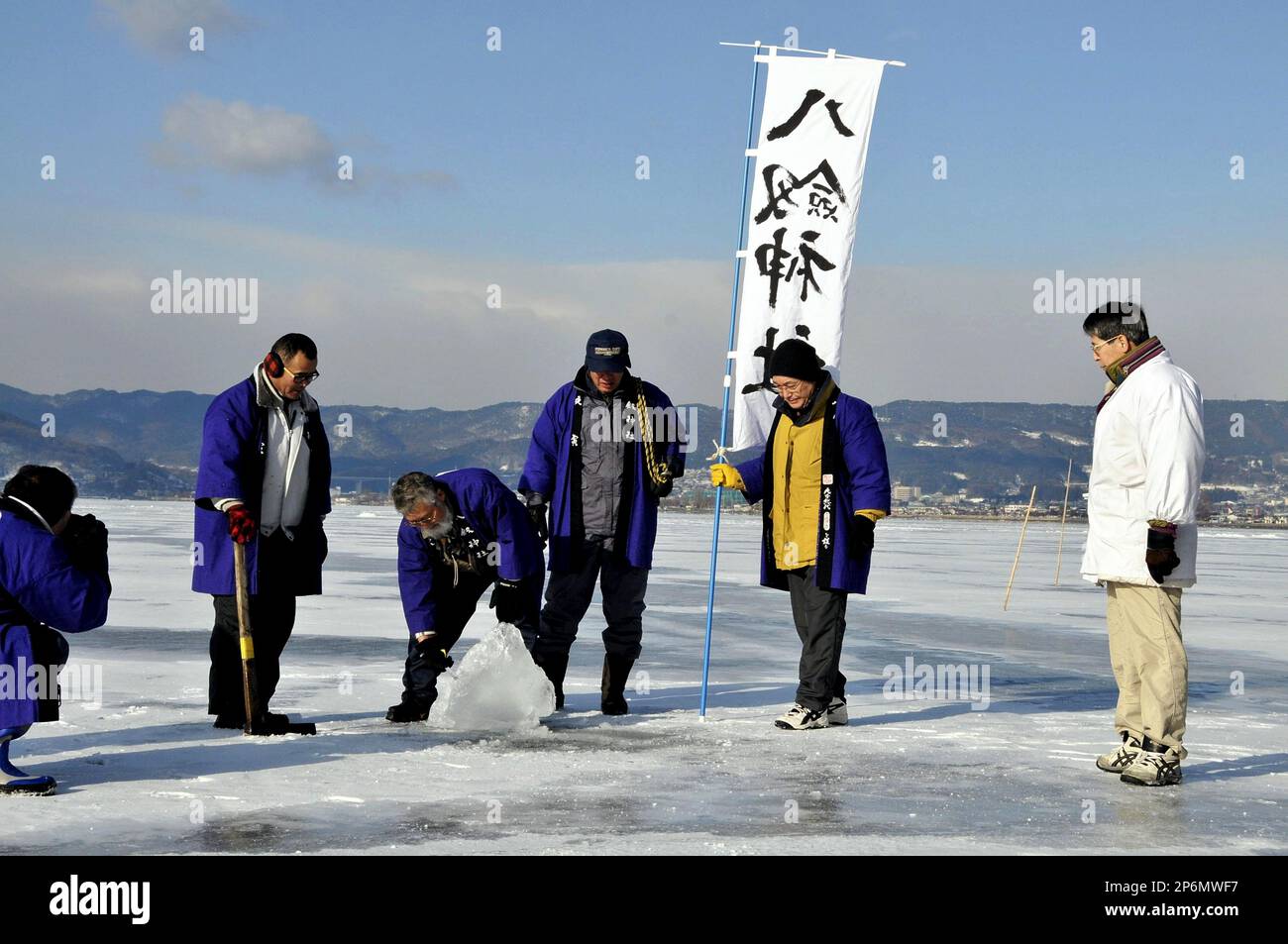 Shinto priest and apprentices of Yatsurugi Shrine measure a thickness ...
