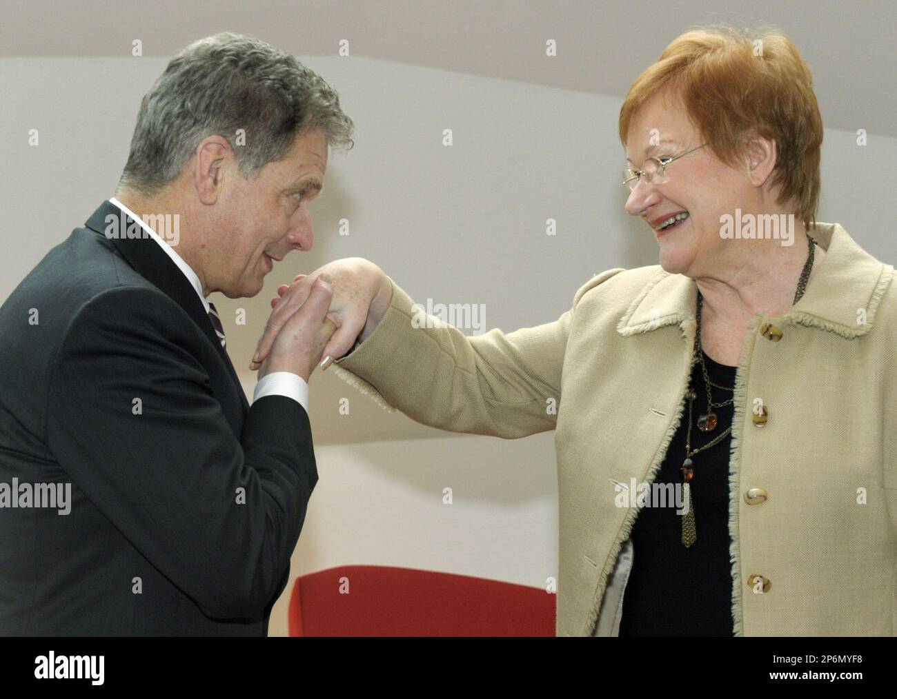Finnish President Tarja Halonen, right, has her hand kissed by ...