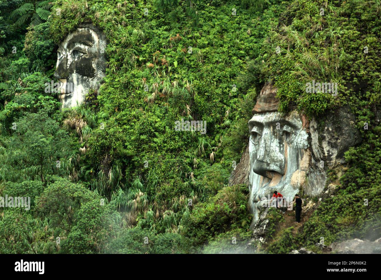 Visitors are having recreational time near a giant face formation ...