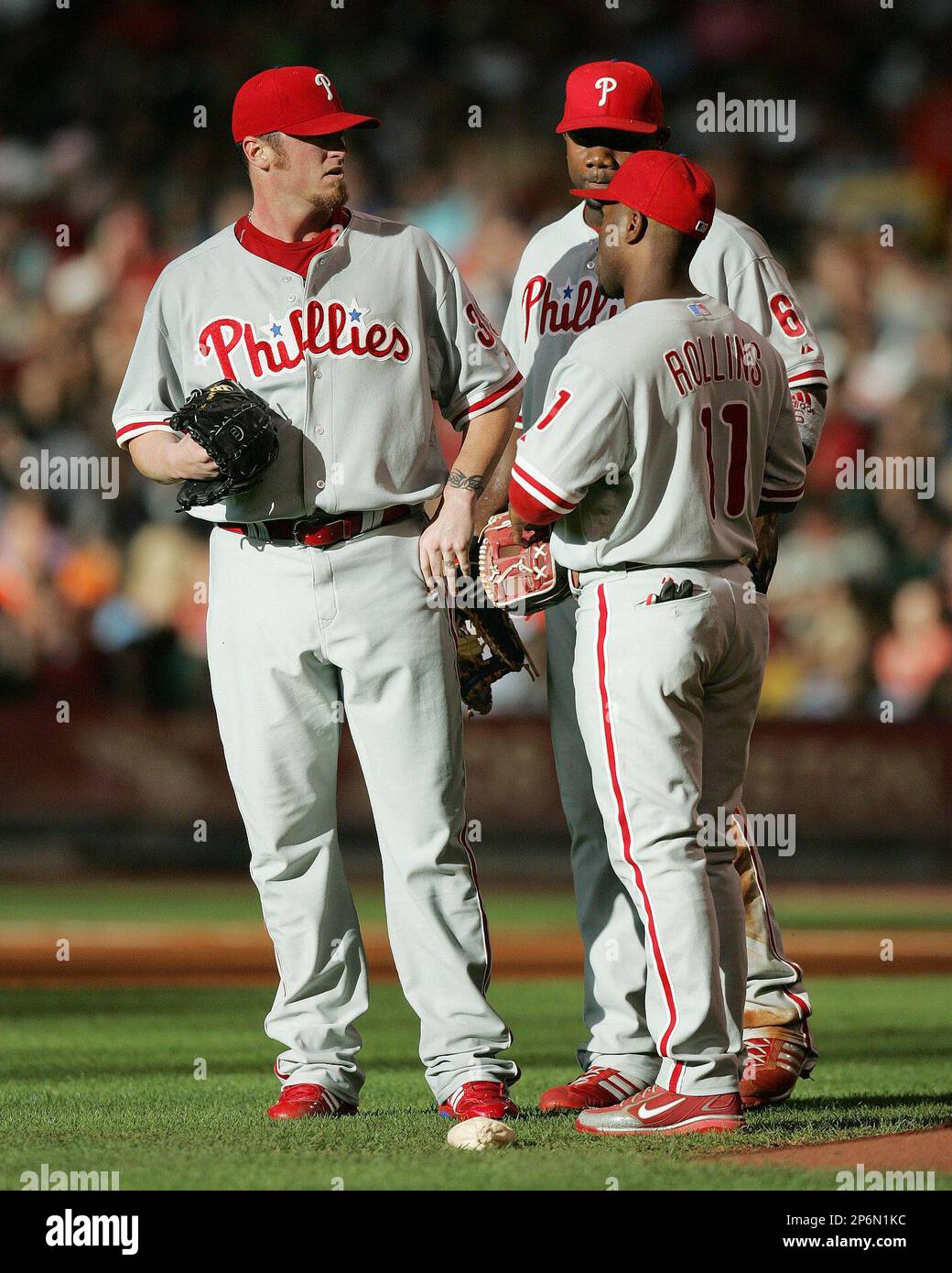 Phillies pitcher Brett Myers talks with SS Jimmy Rollins and 1B Ryan ...