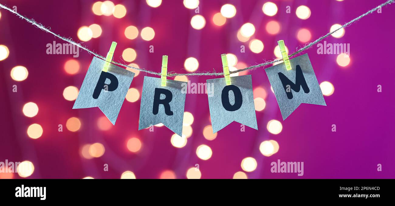 Rope with clothespins and paper word PROM against blurred lights Stock ...