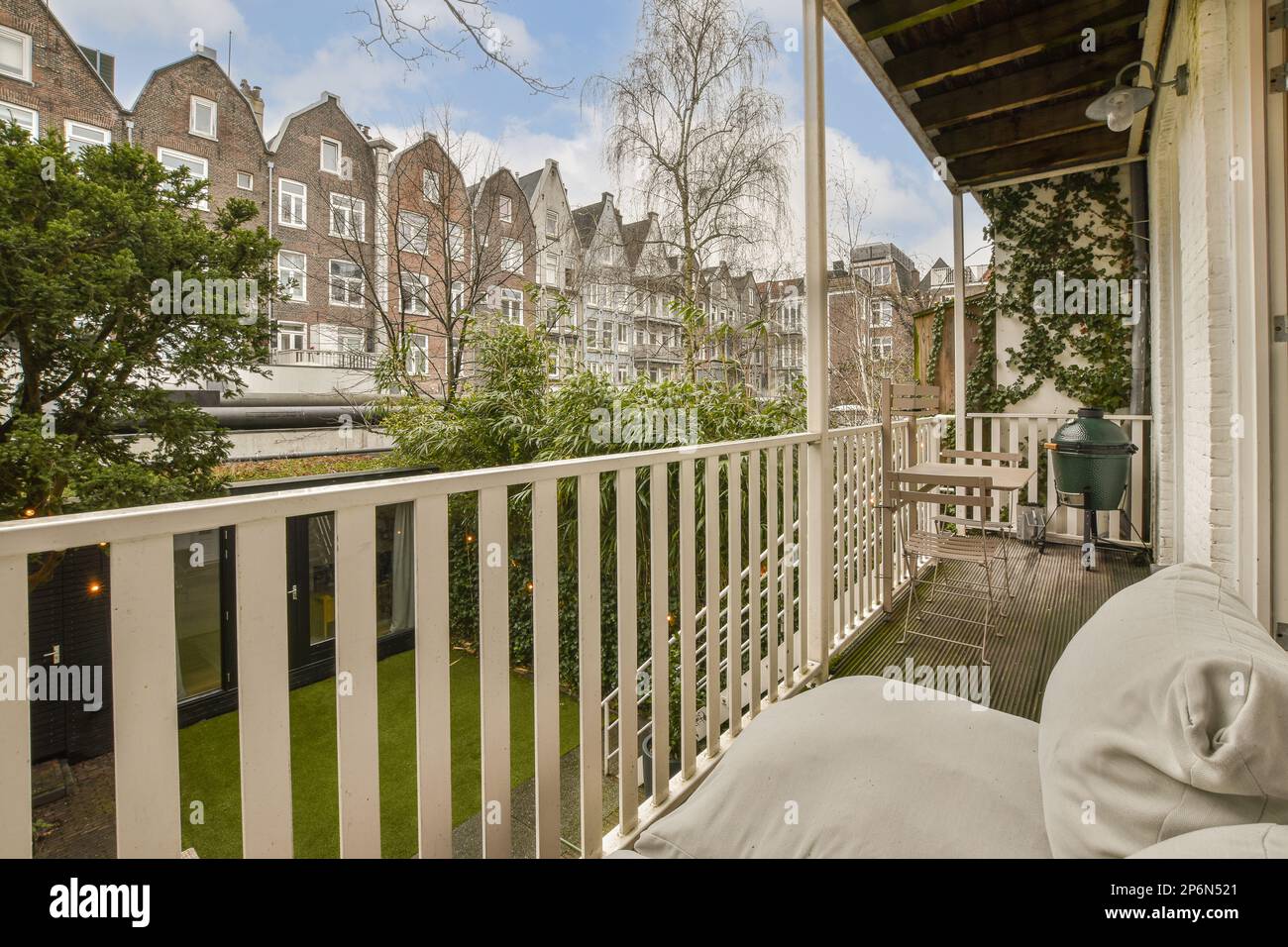 a balcony with some trees and buildings in the background, taken from ...