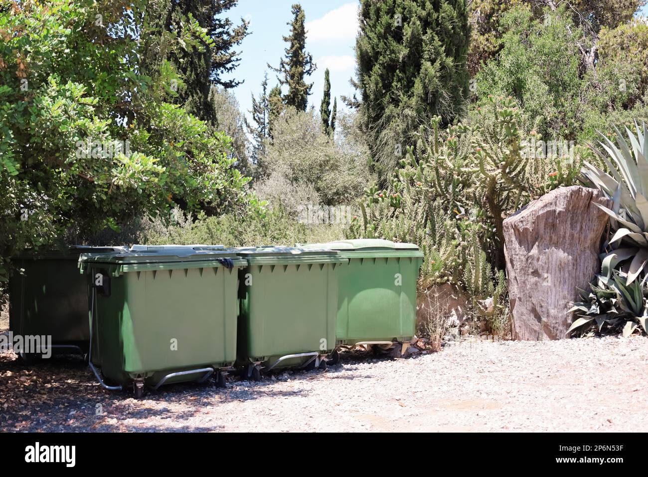 Green garbage containers in park Stock Photo - Alamy