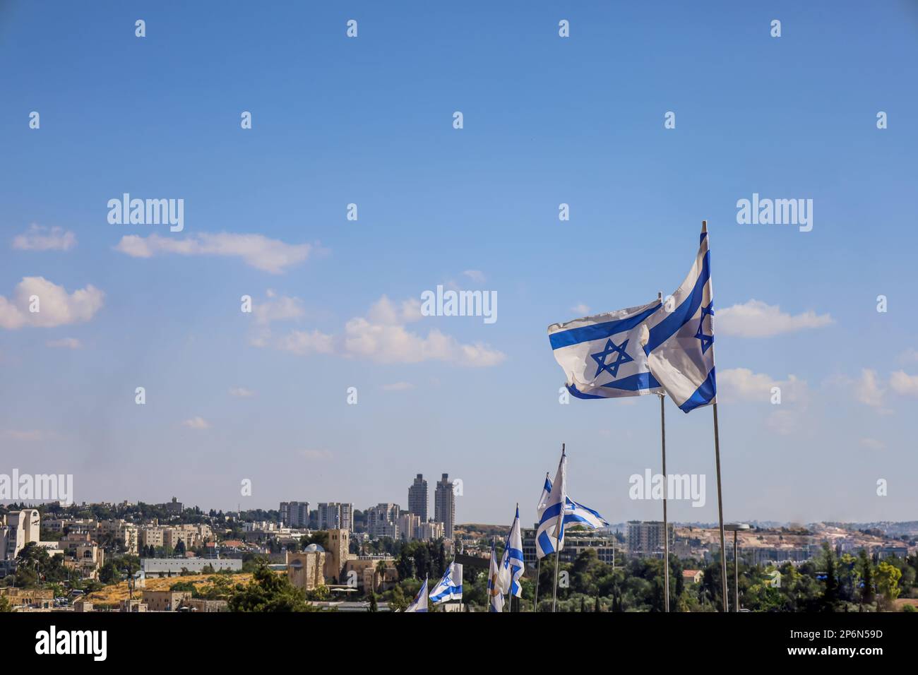 Flags of Israel waving against cityscape background Stock Photo - Alamy