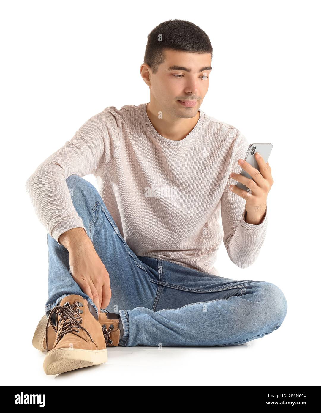 Handsome guy using mobile phone on white background Stock Photo - Alamy