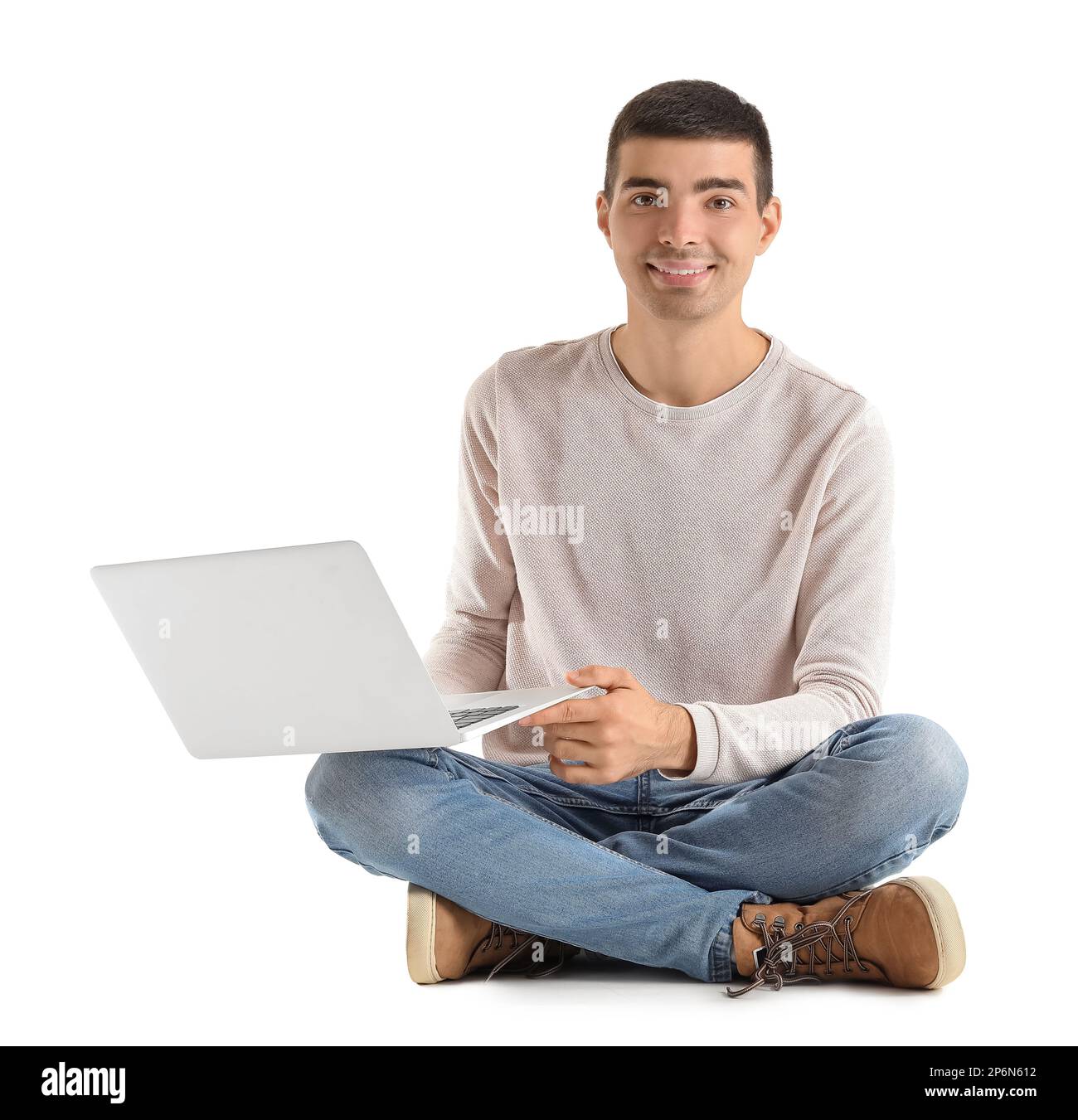 Handsome guy with laptop sitting on white background Stock Photo - Alamy