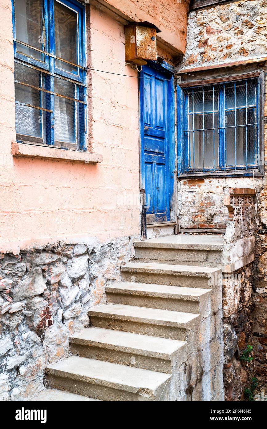 Door and window painted blue colour on facade of old turkish village ...