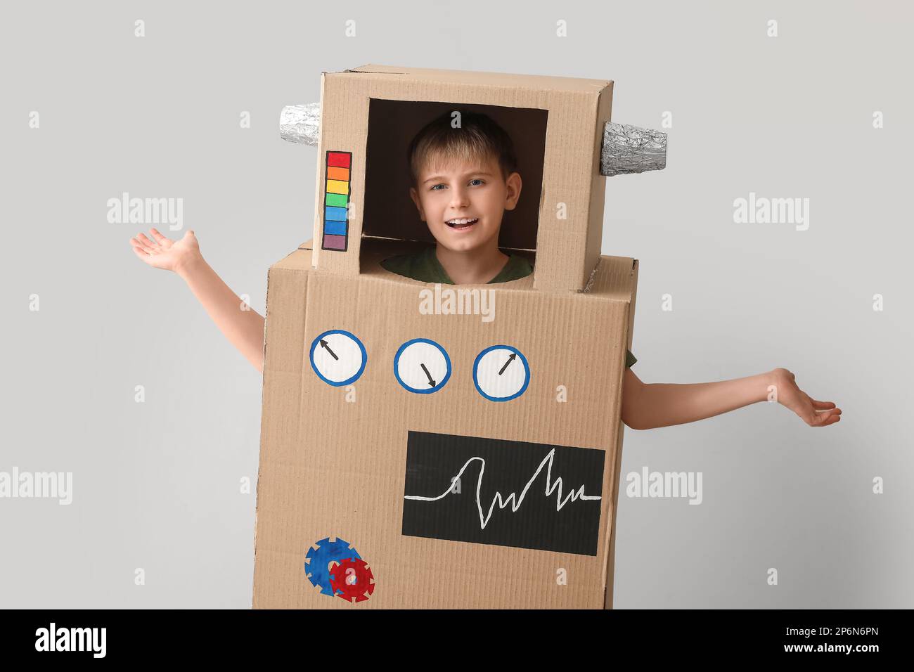 Little boy in cardboard robot costume near light wall Stock Photo - Alamy