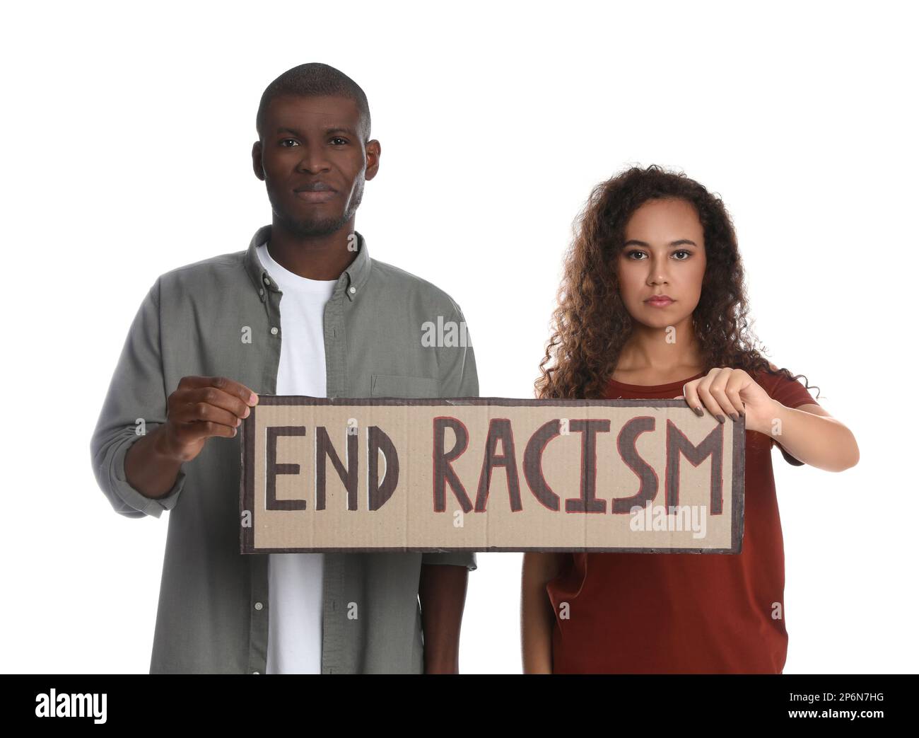 African American woman and man holding sign with phrase End Racism on ...