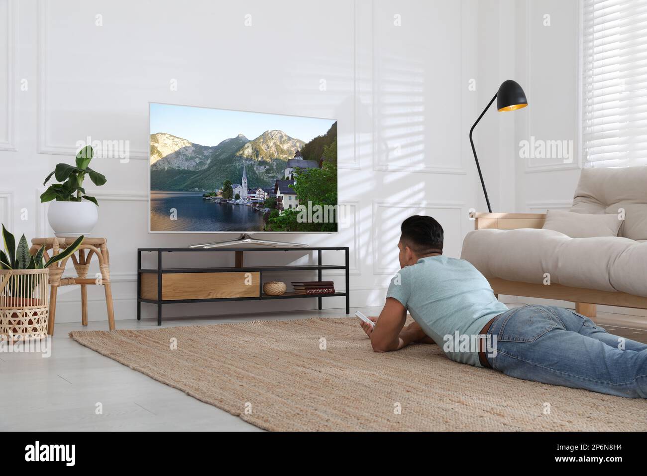 Man watching television at home. Living room interior with TV on stand ...