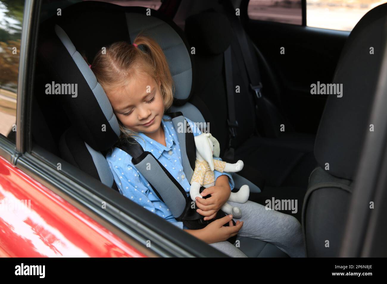 Cute little girl sleeping in child safety seat inside car Stock Photo ...
