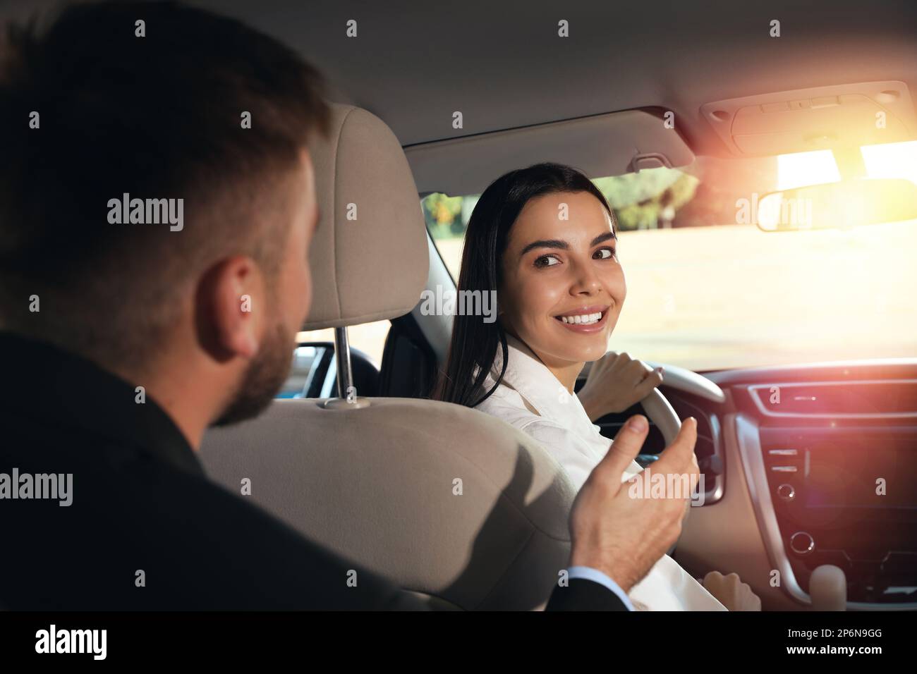 Young man talking with driver in modern car Stock Photo - Alamy